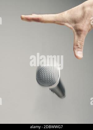 Man hand dropping the microphone Stock Photo - Alamy