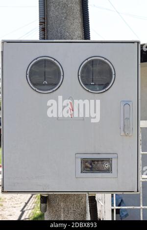 Electricity meter box with round windows at pole Stock Photo - Alamy