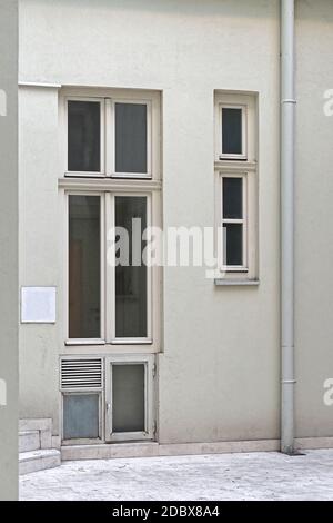 Long vertical windows at white building Stock Photo - Alamy