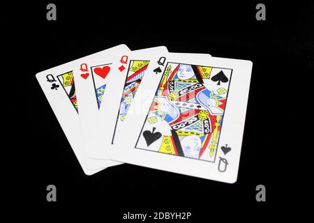 4 Queens in a row - Playing Cards, Isolated on black Stock Photo - Alamy
