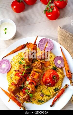 Shish kebabs with vegetables and bulgur Stock Photo - Alamy
