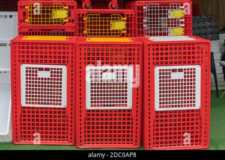 Red Plastic Cages for Birds at Farm Stock Photo - Alamy