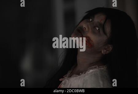 Photo of zombie woman with white face and red flower on her head Stock ...