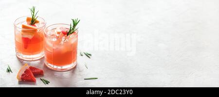 Gin and Tonic cocktail with rosemary and thyme. A cold iced refreshing ...