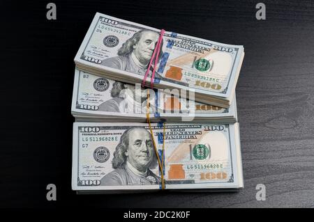 Thirty thousand dollars in packs on a wooden table Stock Photo - Alamy