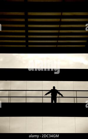 Human figure with arms wide open made of yellow plasticine on white ...