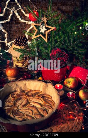 Festive table styling decorated with stars and lights and apple pie on ...
