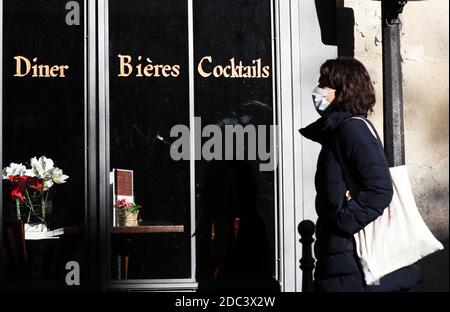 Paris, France. 18th Nov, 2020. People line up in front of an outlet of ...