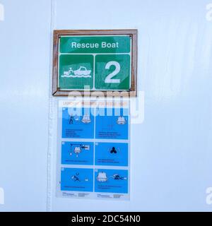 A cruise ship sign designating the rescue boat launching procedure in ...