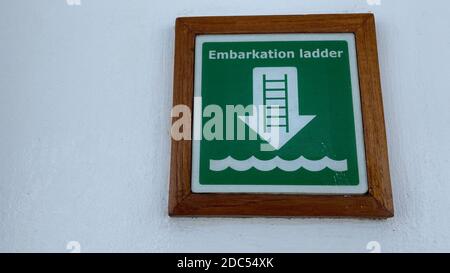 White life raft and embarkation ladder on deck of container ship ready ...