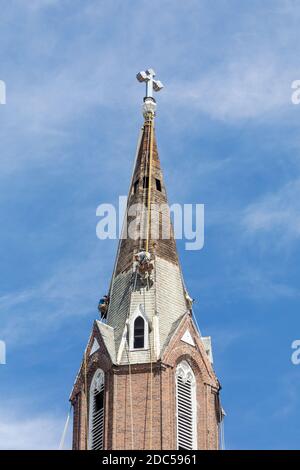Workers repair the steeple of Saint John’s Church in Burlington, Iowa ...