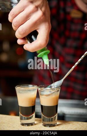 Barman make alcoholic shots with rum and liquor Stock Photo - Alamy