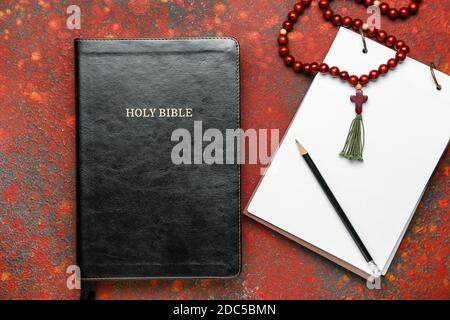 Hole Bible and rosary beads on color background Stock Photo - Alamy