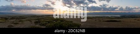 Panorama and sun on Issyk Kul Lake at sunset near Karakol with ...