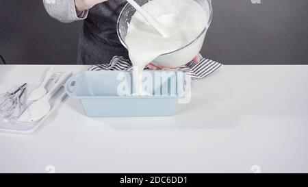 Pouring ice cream mixture into the baking pan to be frozen Stock Photo ...