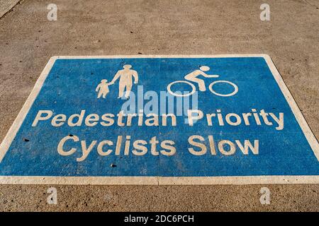 Slow - Pedestrian Priority sign on pathway Stock Photo - Alamy