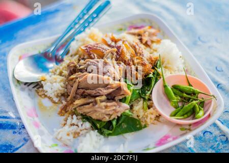 Kao ka moo, a popular Thai street food dish of slow braised pork leg in ...