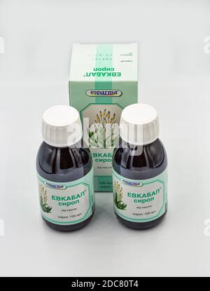 Bottles of cough syrup and measuring cup on white background Stock ...