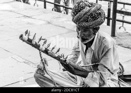 the roadside poor musician/ street artist playing a traditional ...