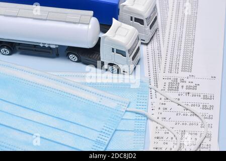 Two lorry toys, and face mask in concept about transport departament ...