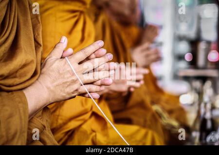 A group of Buddhist people pray together in a temple Stock Photo - Alamy