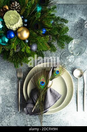 Festive table setting decorated with peacock feather for Christmas ...