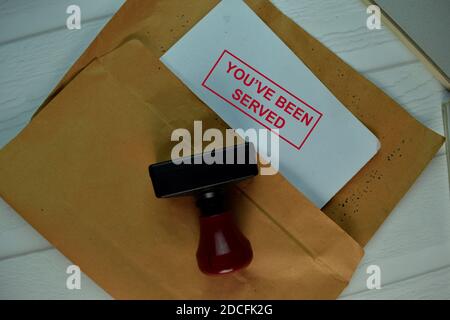 Red Handle Rubber Stamper and You've Been Served text above brown ...