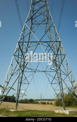Green field with pylons and trees in panorama Stock Photo - Alamy