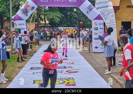 Lagos, Nigeria, 21st November 2020. Officials carry an exhausted runner ...