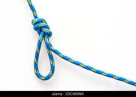 Figure 8 Directional Loop knot on yellow and black nylon rope on white ...