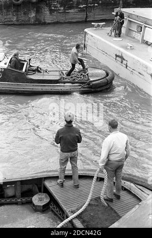 Lightermen of the River Thames working on the barges. working jumping ...