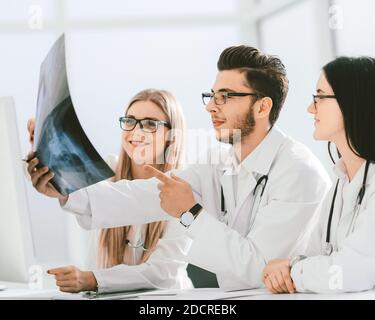 doctors experts discuss x-ray,sitting at the table .photo with copy ...
