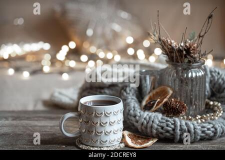 Beautiful winter composition with cup of hot drink, on wooden table ...