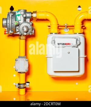 Natural gas meter with yellow pipes measuring gas consumption. An ...