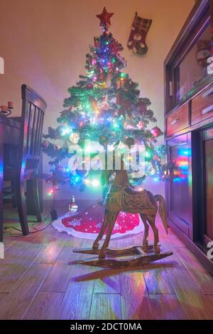 Christmas decoration in grunge room interior with fireplace, horse ...