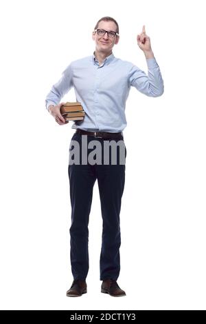 Man pointing at a pile of books and people sitting in school chairs in ...