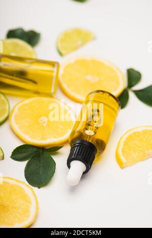 Bottles of citrus essential oil on light background Stock Photo - Alamy