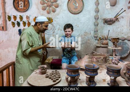 An Islamic potter teaching a boy making ceramic pots in Heritage ...