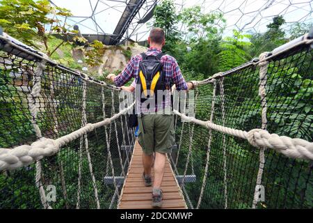The Eden Project rainforest biome with a young girl standing on a ...