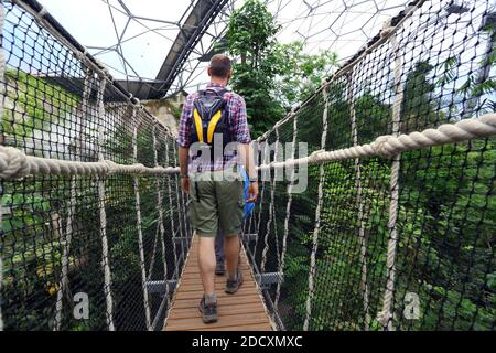 The Eden Project rainforest biome with a young girl standing on a ...