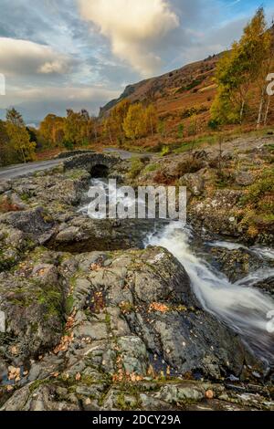 A beautiful view of an old stone bridge over river with rocks Stock ...