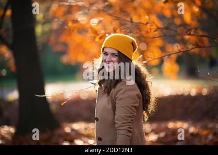 Hello september. smiling young woman in scarf with leather gloves and ...