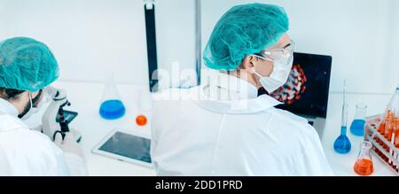 rear view. scientist sitting at a Desk in the laboratory Stock Photo ...