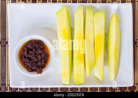 Slices of green mangos with traditional Filipino fermented shrimp paste ...