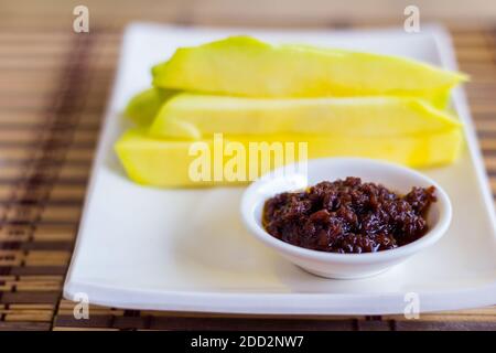 Slices of green mangos with traditional Filipino fermented shrimp paste ...