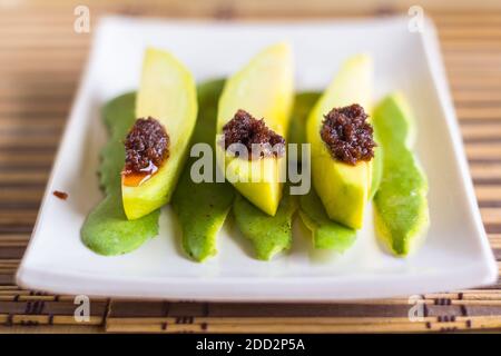 Slices of green mangos with traditional Filipino fermented shrimp paste ...