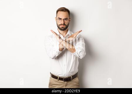 Angry businessman frowning and showing cross, stop you, telling no and ...