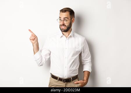 Young bearded guy seeing something disturbing, cringe while pointing ...