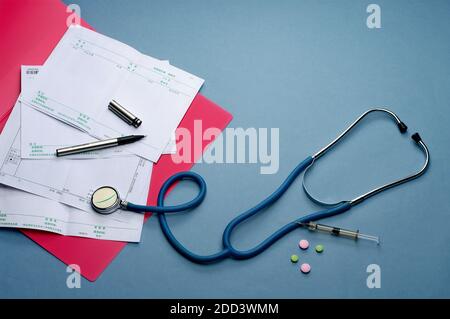 Red stethoscope with prescription on blue background Stock Photo - Alamy