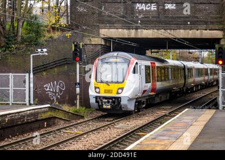 British Rail Class 720 Aventra of Greater Anglia passing at speed through countryside near ...